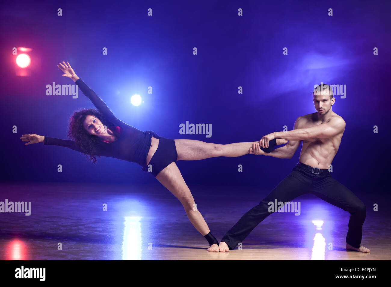 A man and a woman performing a contemporary dance pose on a stage Stock ...