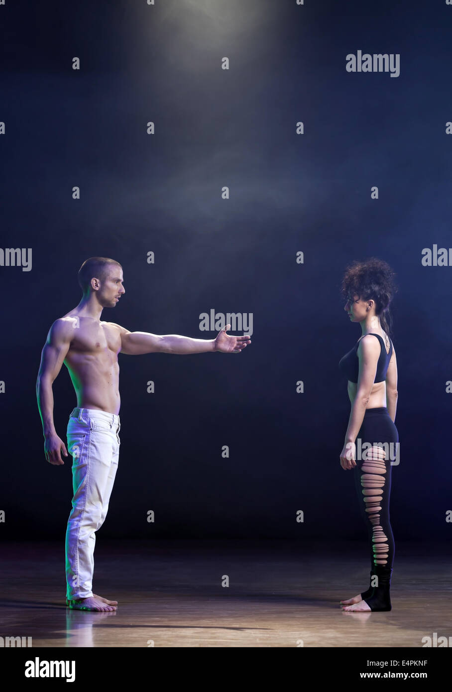 A man and a woman performing a contemporary dance pose on a stage Stock ...