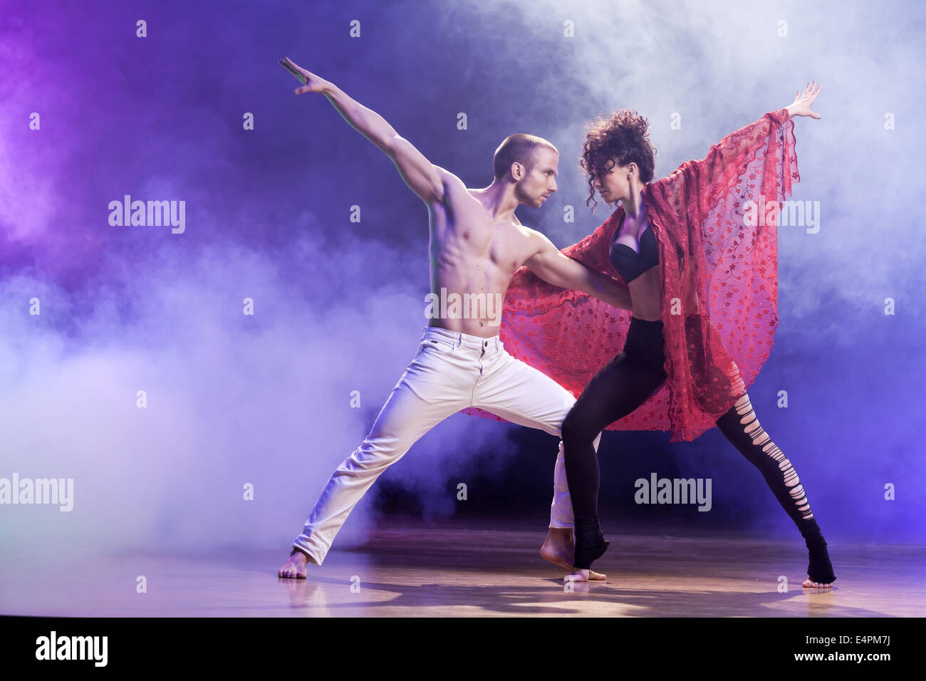 A man and a woman performing a contemporary dance pose on a stage Stock ...