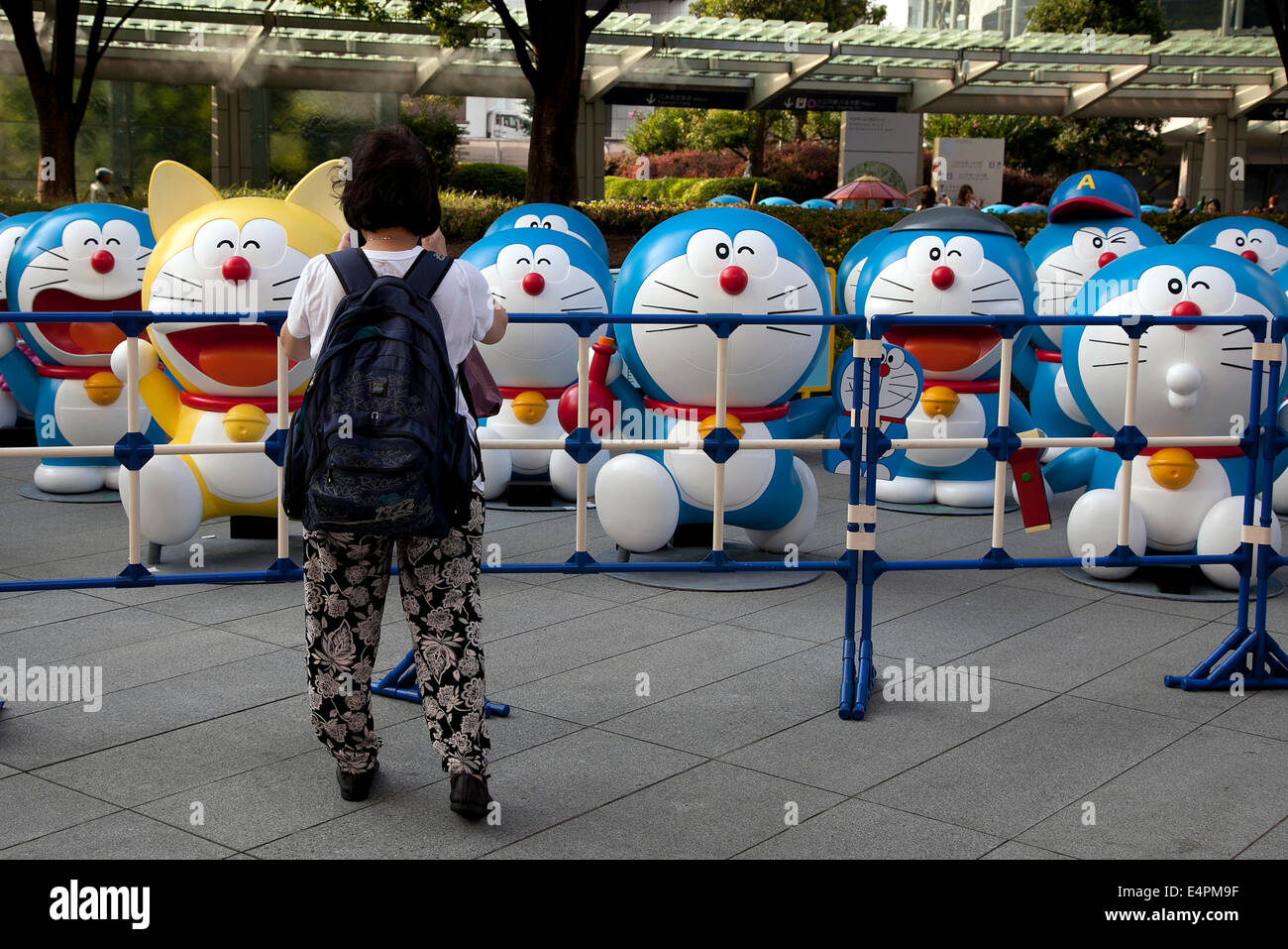 Tokyo, Japan. 16th July, 2014. People take pictures of Doraemon statues ...