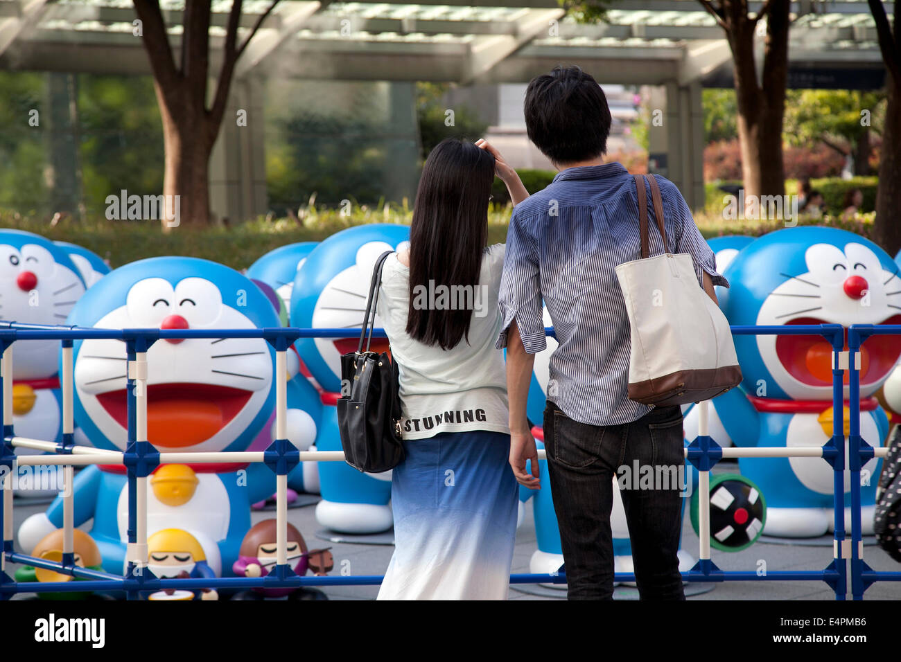 Tokyo, Japan. 16th July, 2014. People take pictures of Doraemon statues ...