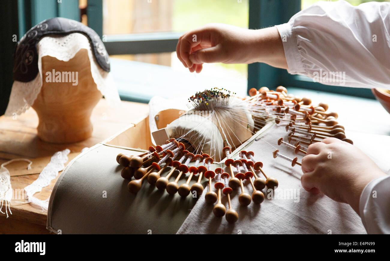 Bobbin lace being produced with the traditional method by hand with ...