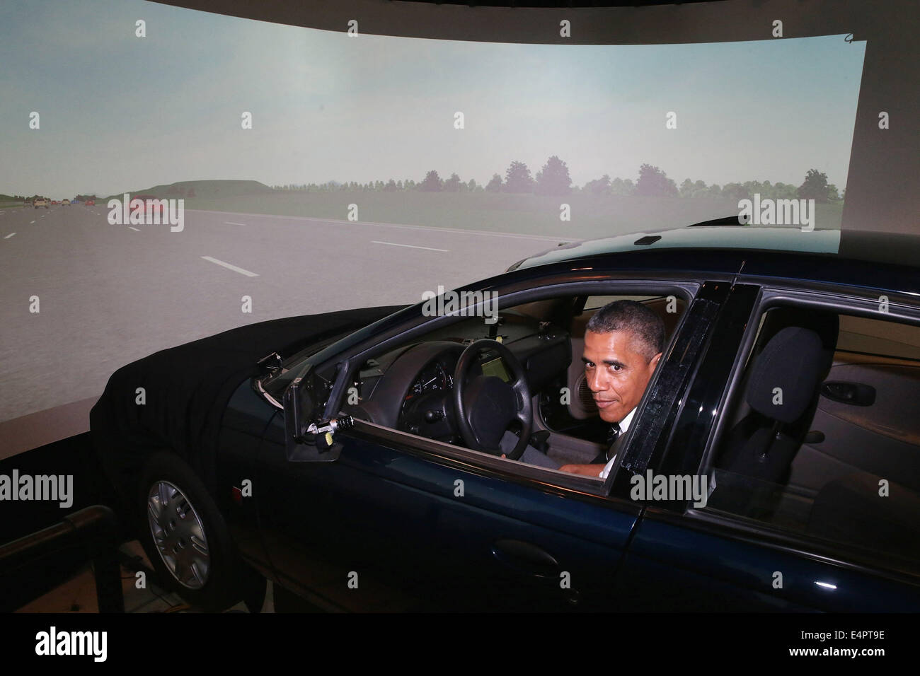 United States President Barack Obama sits behind the wheel of a driving ...