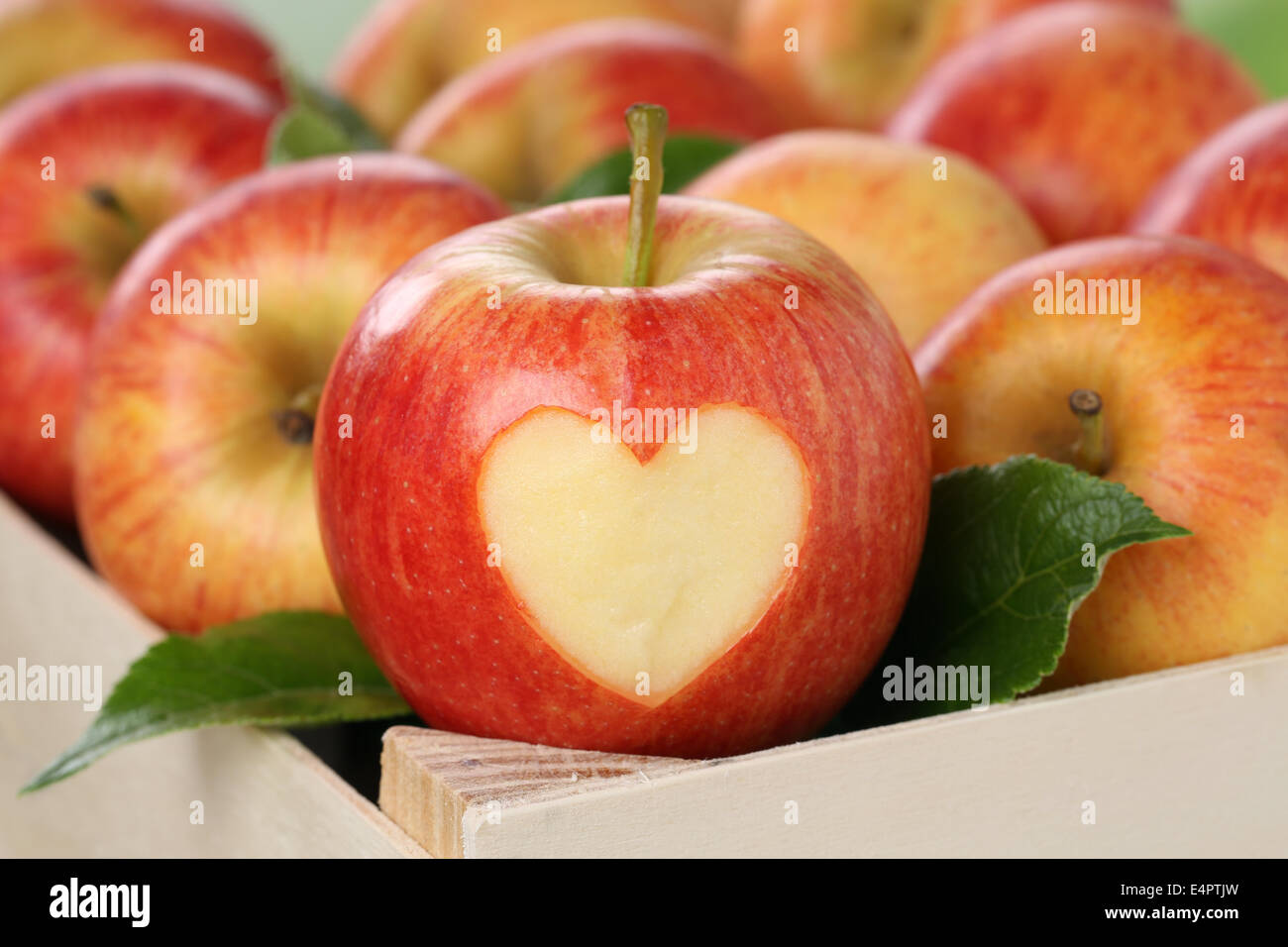 Apple with heart in a box love topic Stock Photo - Alamy