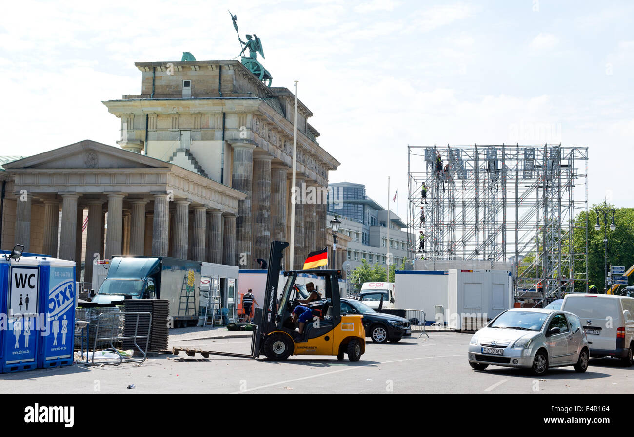 A forklift truck with a German flag drives by as workers dismantle the ...
