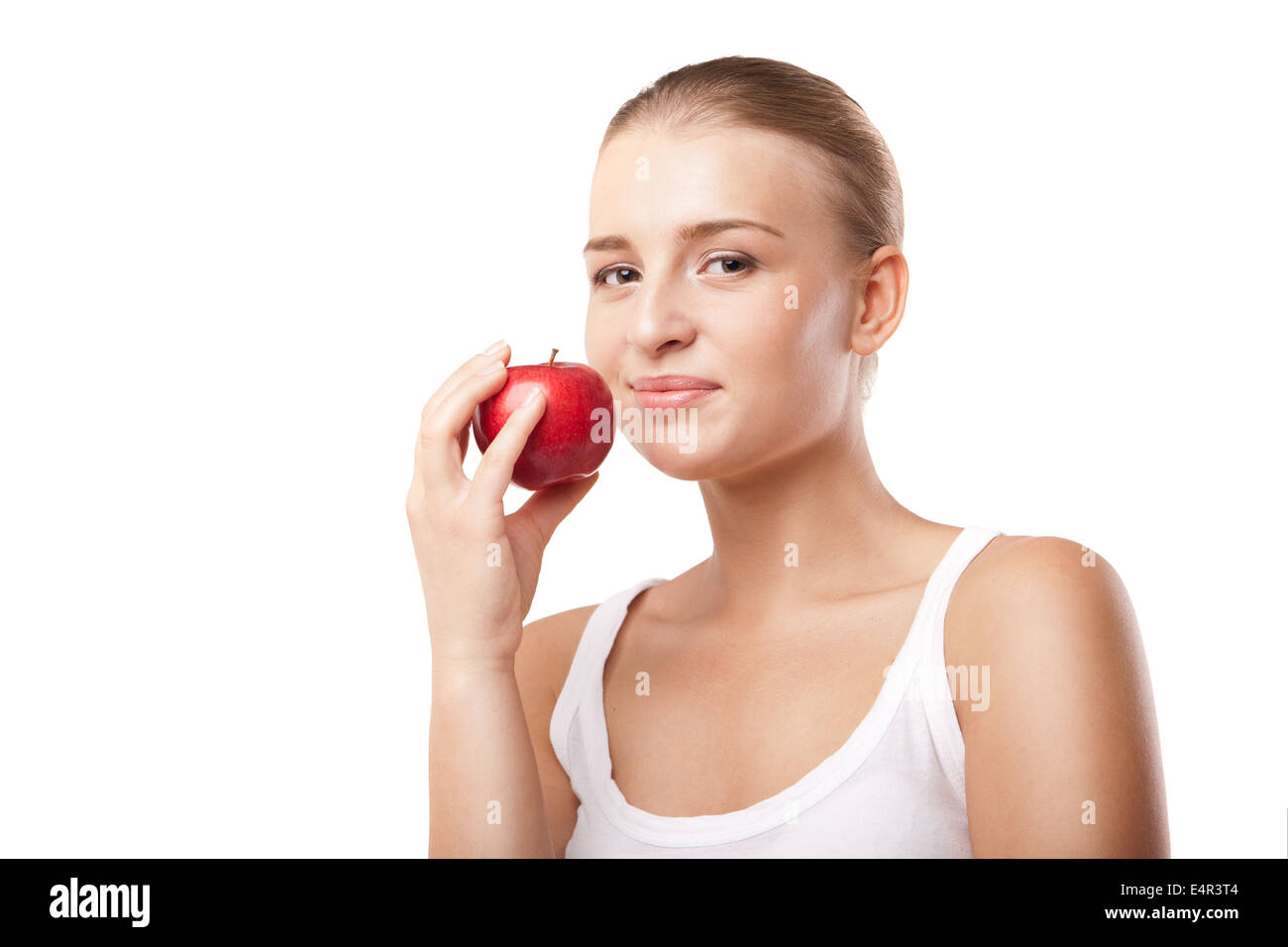 Smiling blond woman eating red apple on white background Stock Photo ...