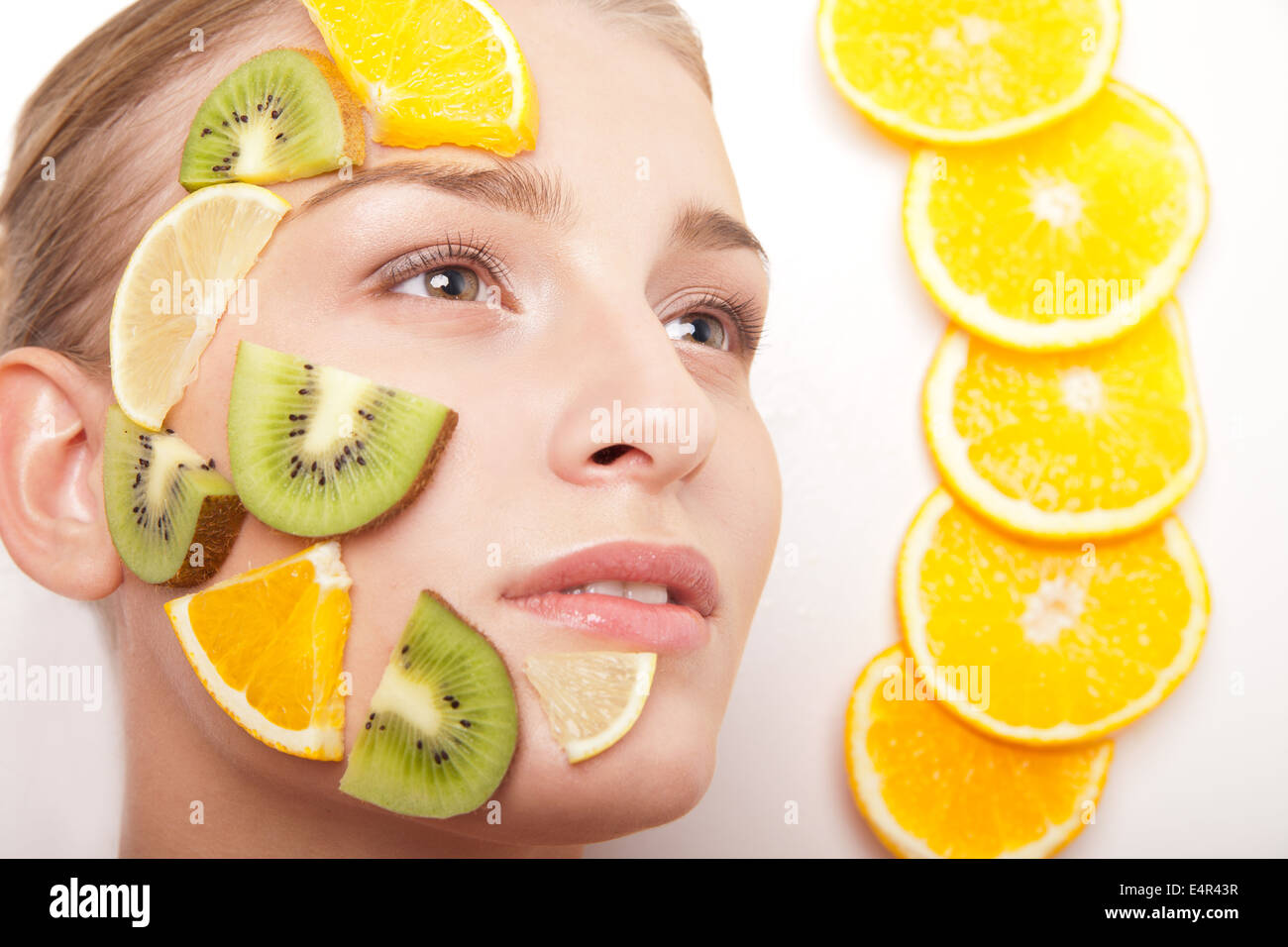 Smiling woman with fruit mask on her face isolated Stock Photo - Alamy