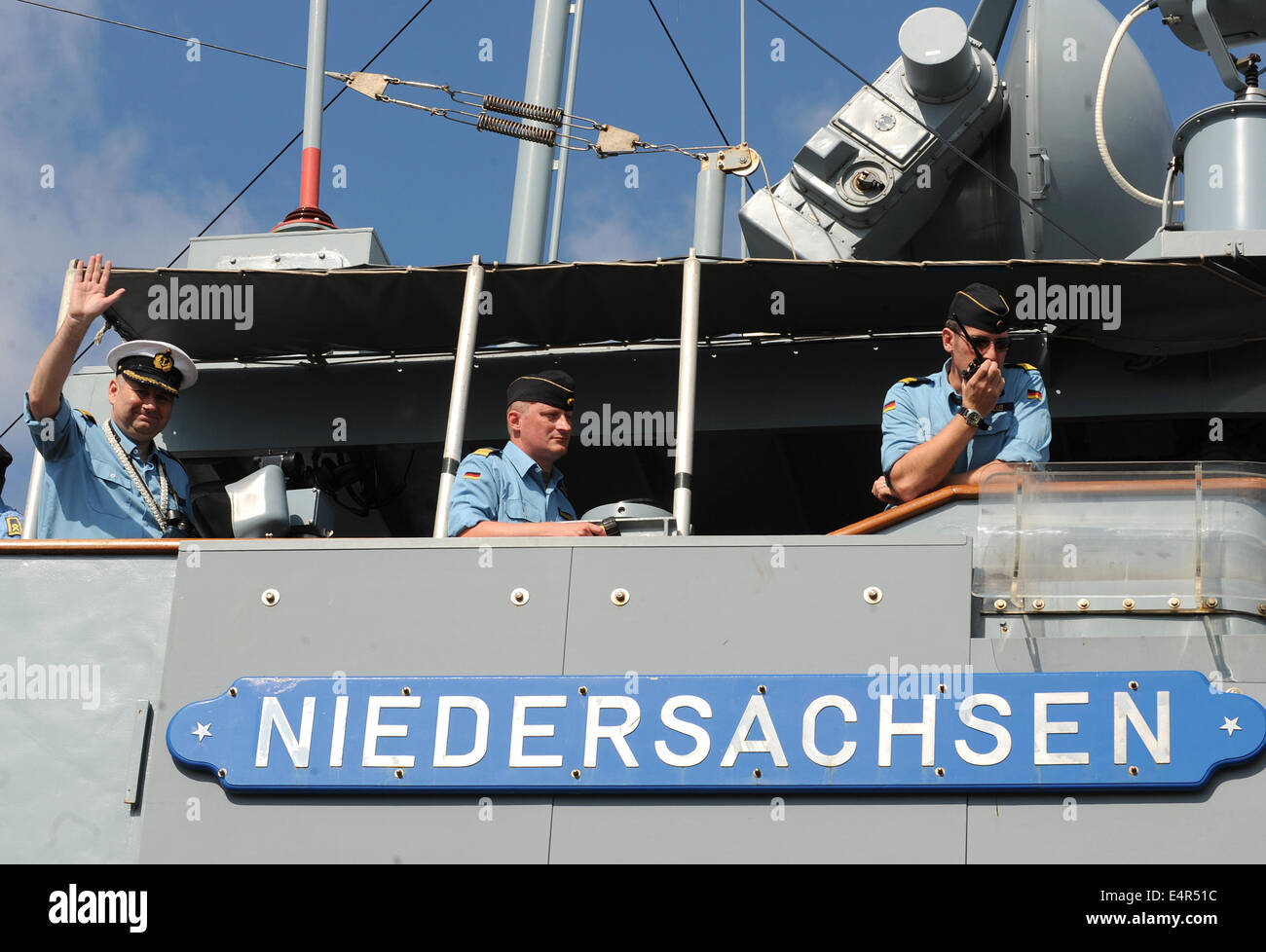 Commanding officer Captain Kurt Leonards (L), and members of the crew ...