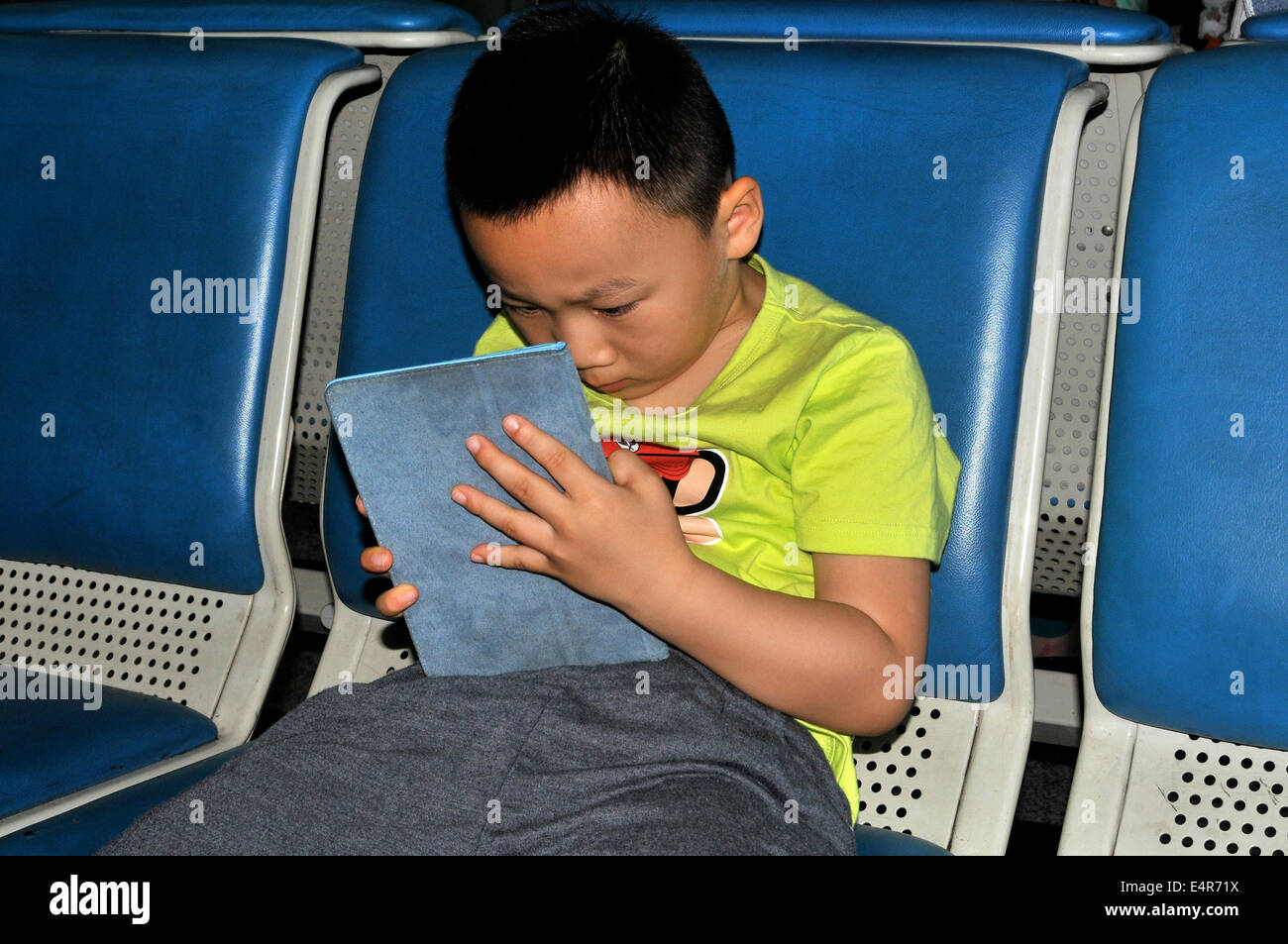 young chinese boy playing with electronic board Xi"Ian international ...