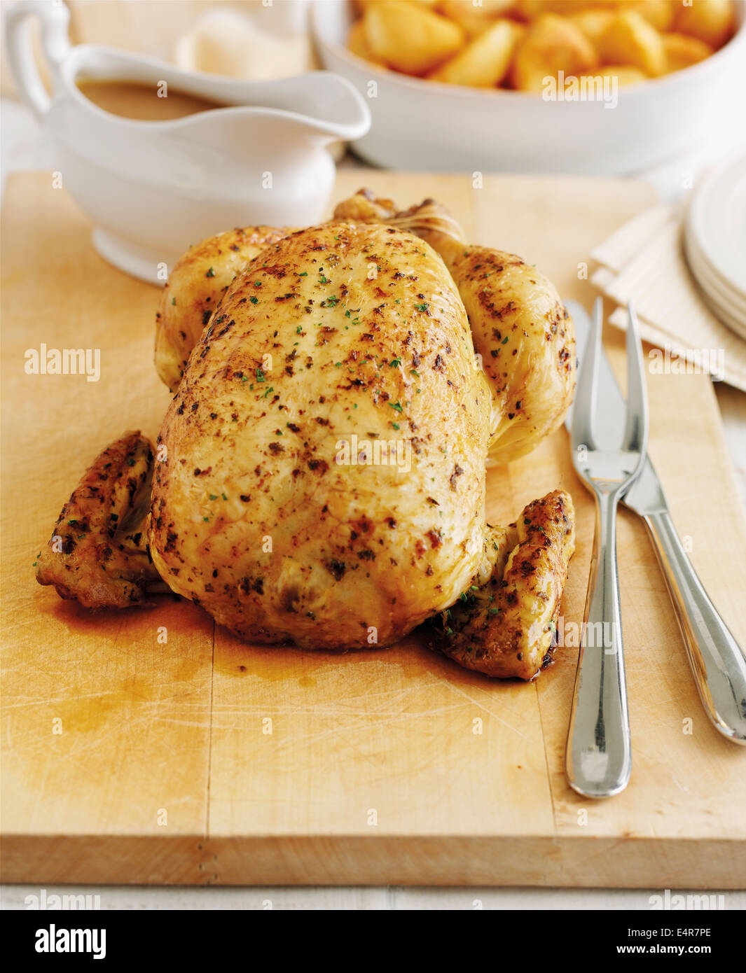 Roast chicken basted in herb butter Stock Photo - Alamy