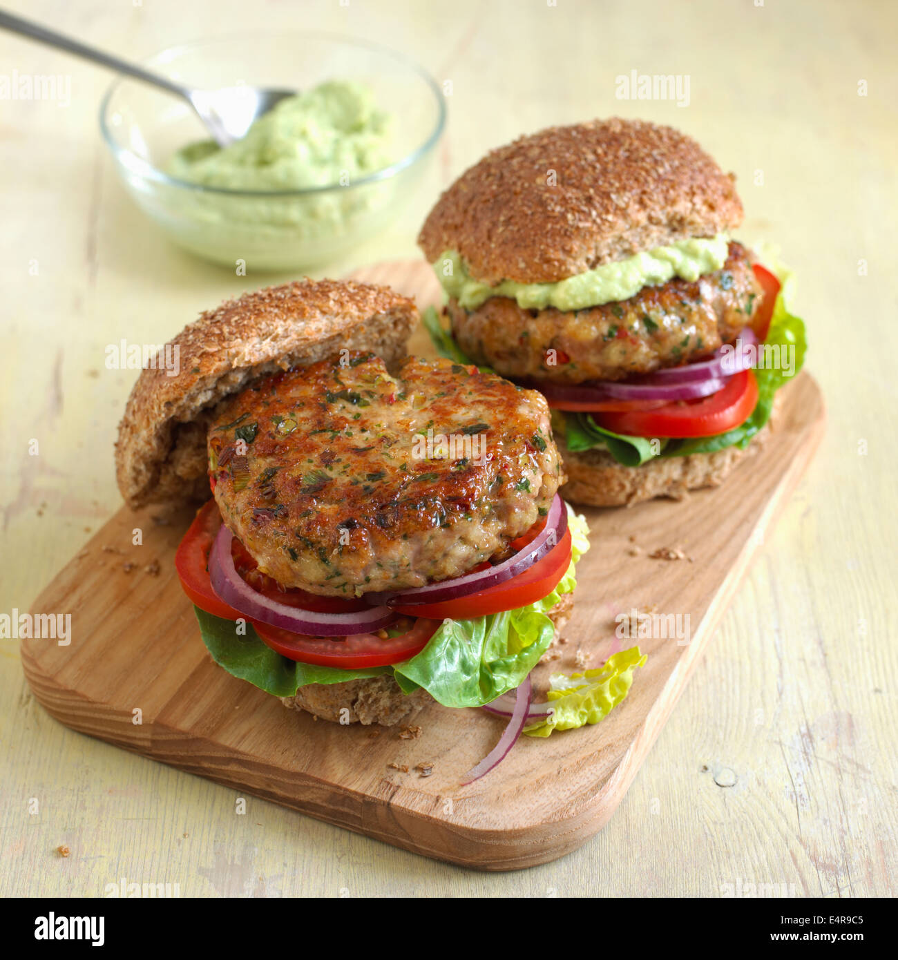 Spicy turkey burgers in wholemeal rolls, with avocado cream Stock Photo ...