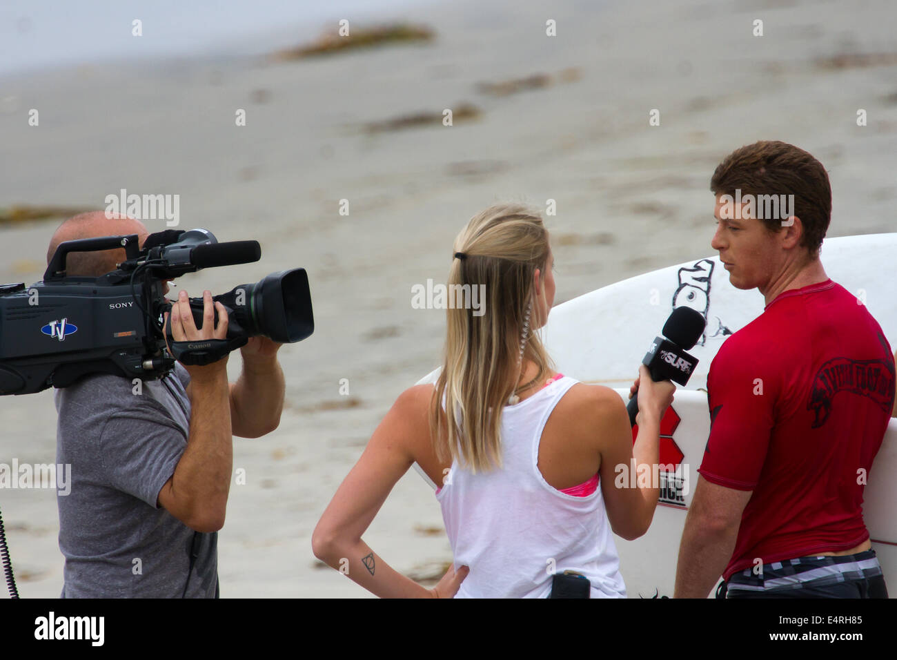 Reporter interviewing surfing contestant for Bro-Am Stock Photo - Alamy