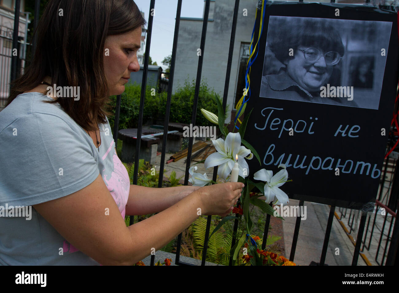 Kiev, Ukraine. 16th July, 2014. A woman lits a candle in front of the ...