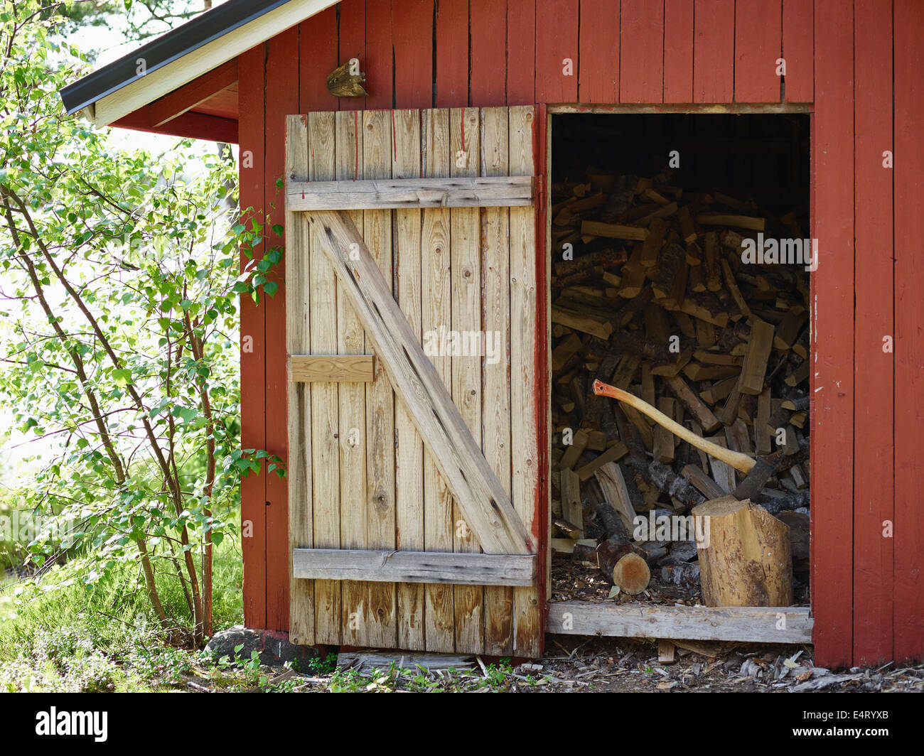 An axe and the woodpile inside a storage Stock Photo - Alamy