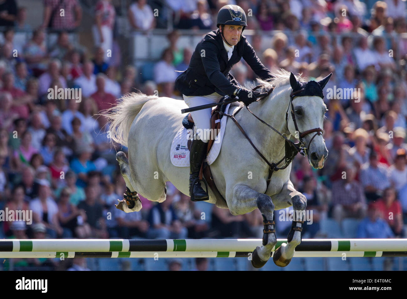 Aachen, Germany. 16th July, 2014. Irish rider Shane Breen jumps over an ...