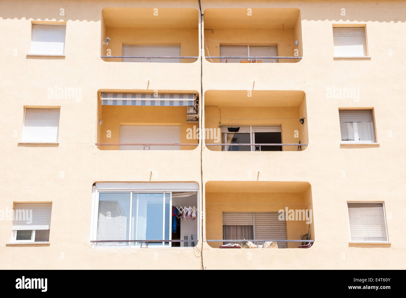 Modern yellow building with large balconies Stock Photo - Alamy