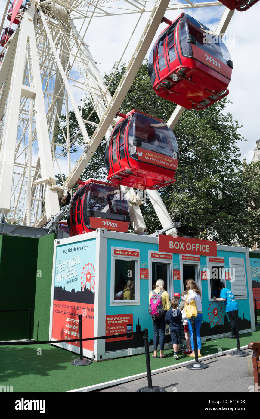 Family booking a ride on the Edinburgh Festival Ferris Wheel in Princes ...