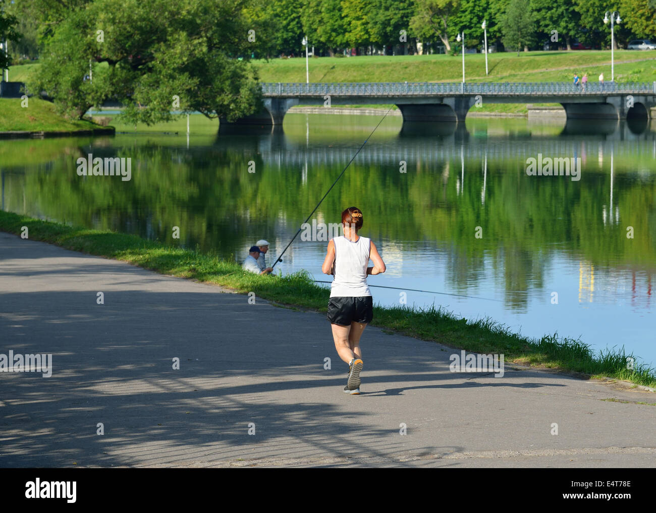 Senior woman running along the waterfront Stock Photo - Alamy