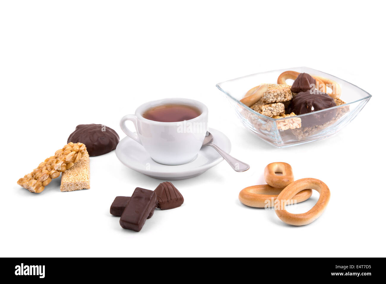 white cup of tea and a selection of sweets on a white background Stock ...