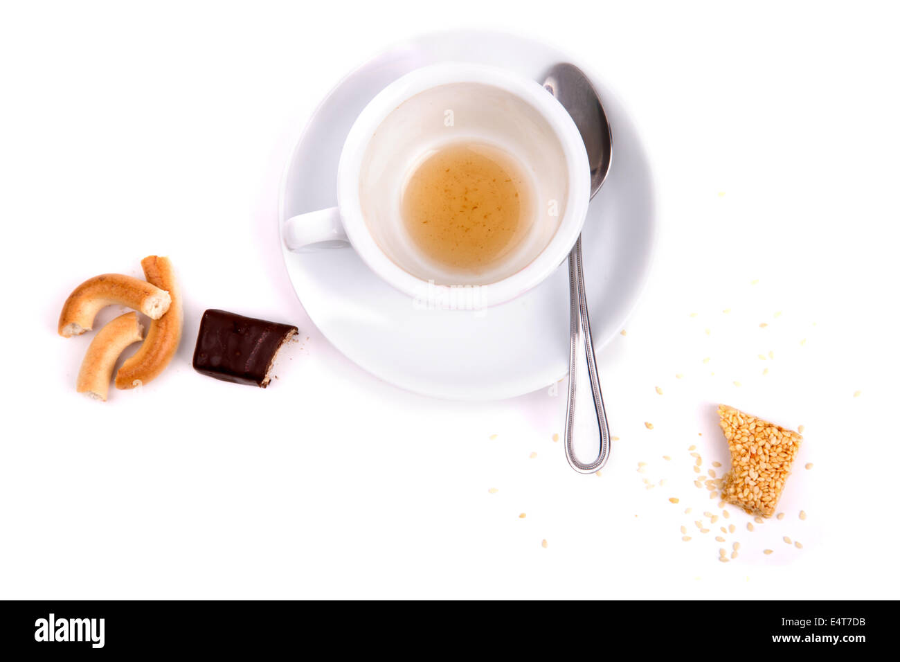 dirty white cup of tea and sweets crumbs on white background Stock ...