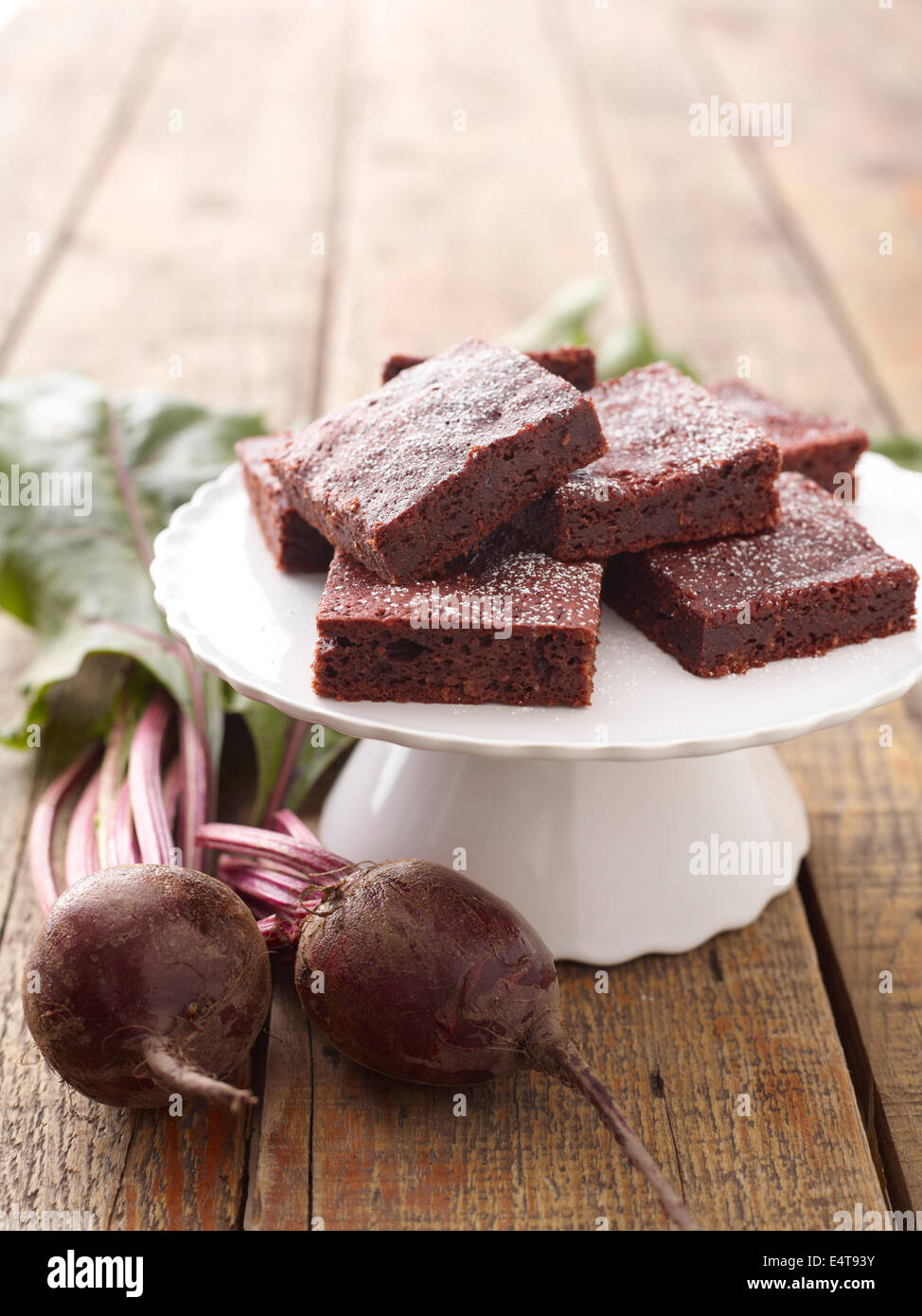 Close-up of beet vegetables next to white cake stand holding beet ...