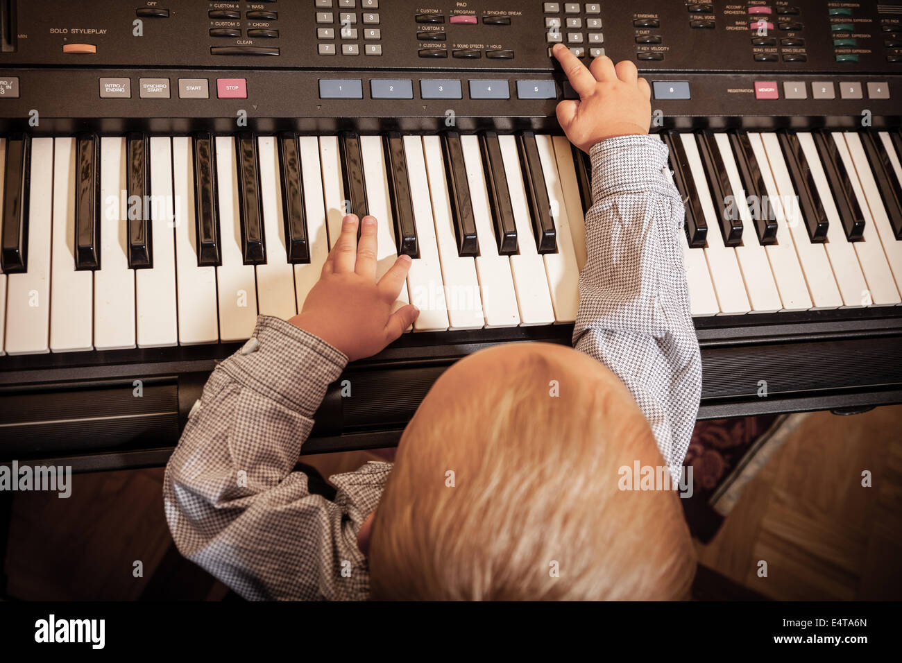 Boy child kid playing on digital keyboard piano synthesizer Stock Photo ...