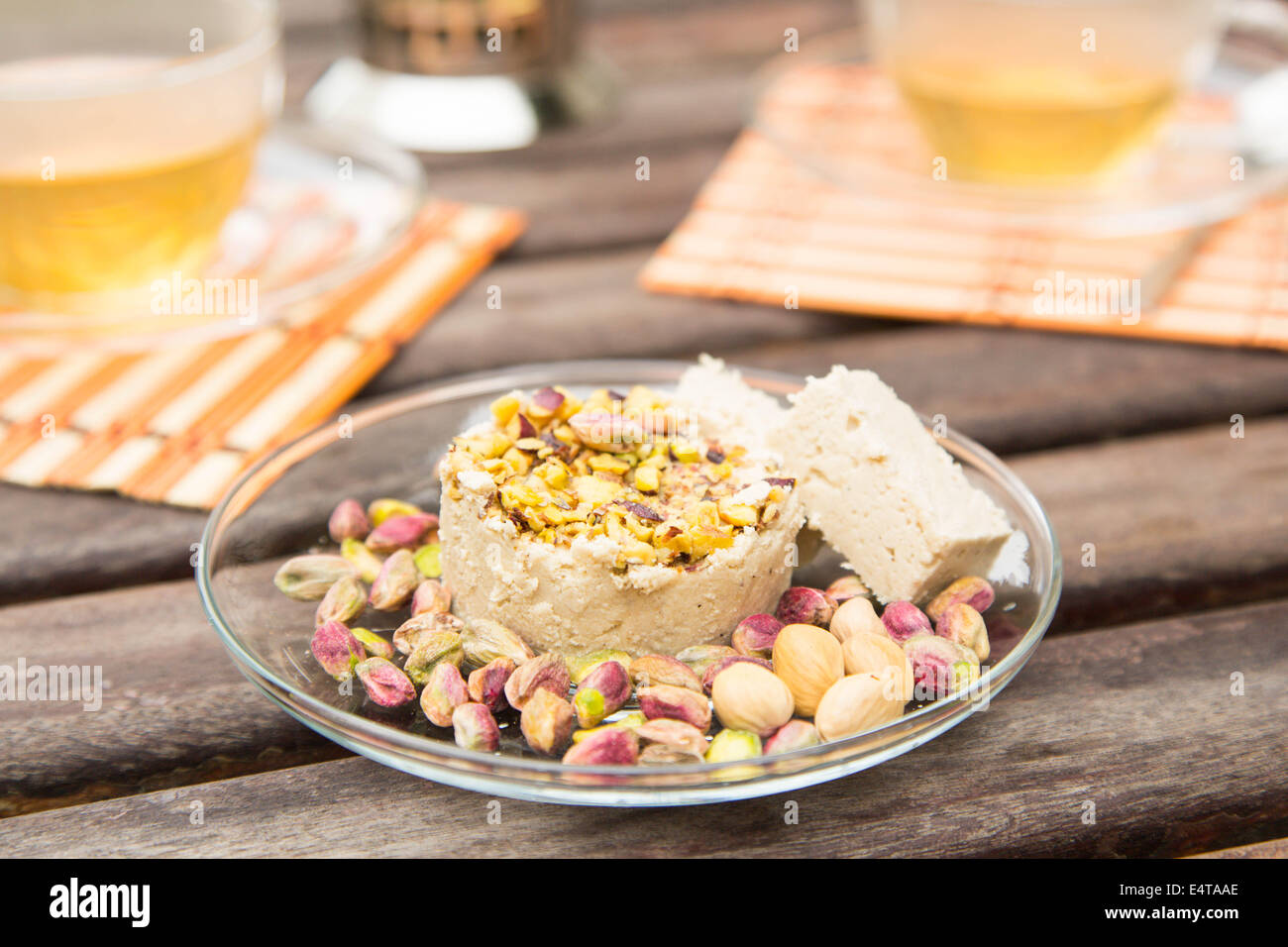 Halvah - paste of sesame with pistachios on the glass plate Stock Photo ...