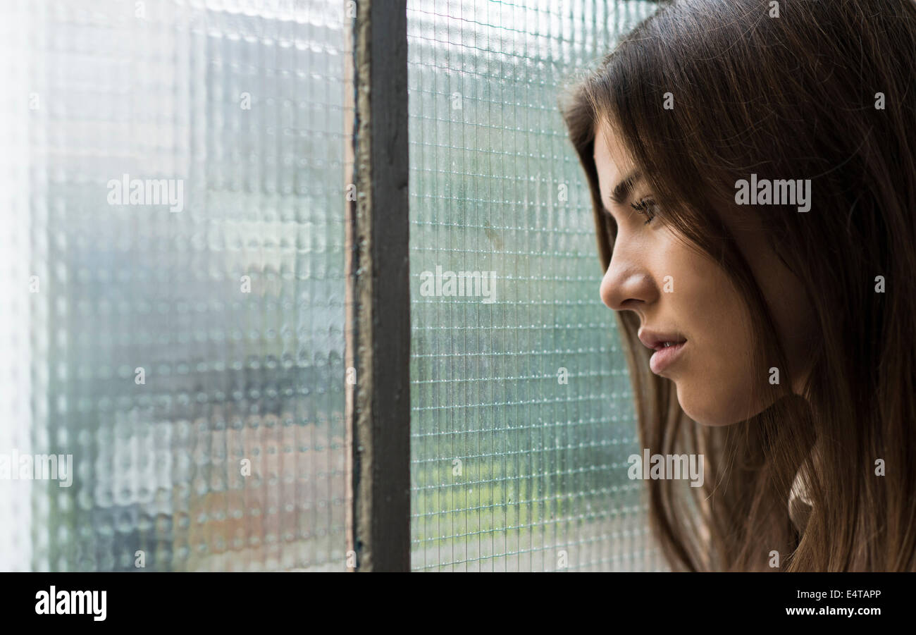 Sad girl window hi-res stock photography and images - Alamy