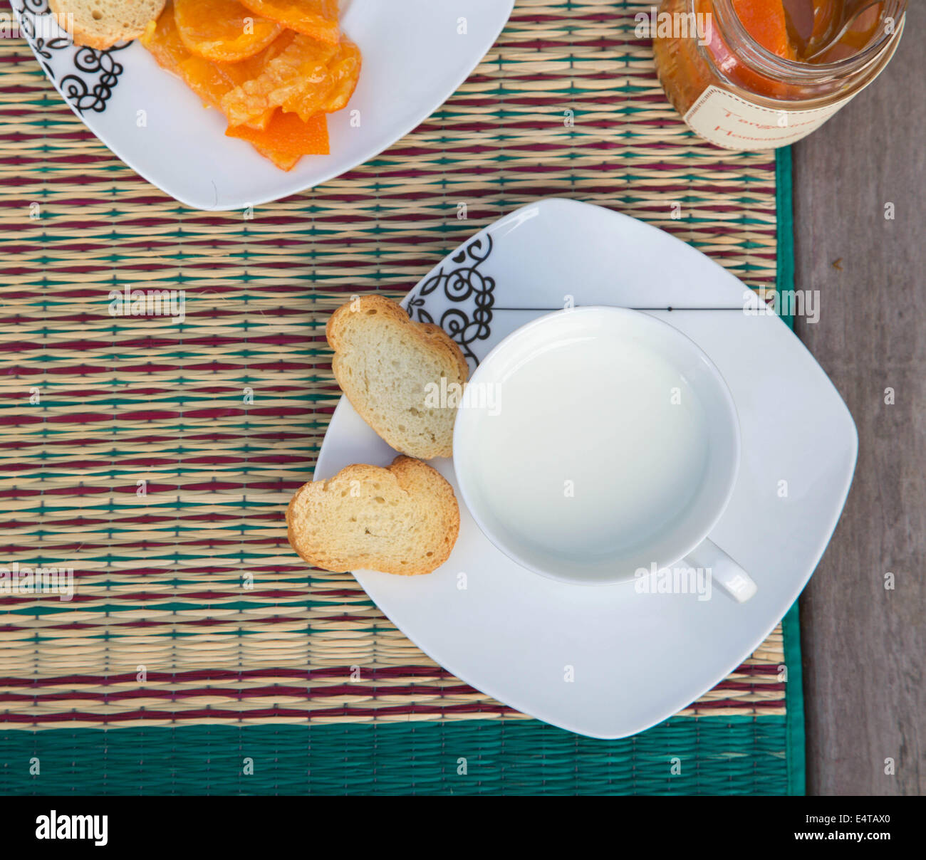 A cup of milk with tangerine marmalade.Top view Stock Photo - Alamy