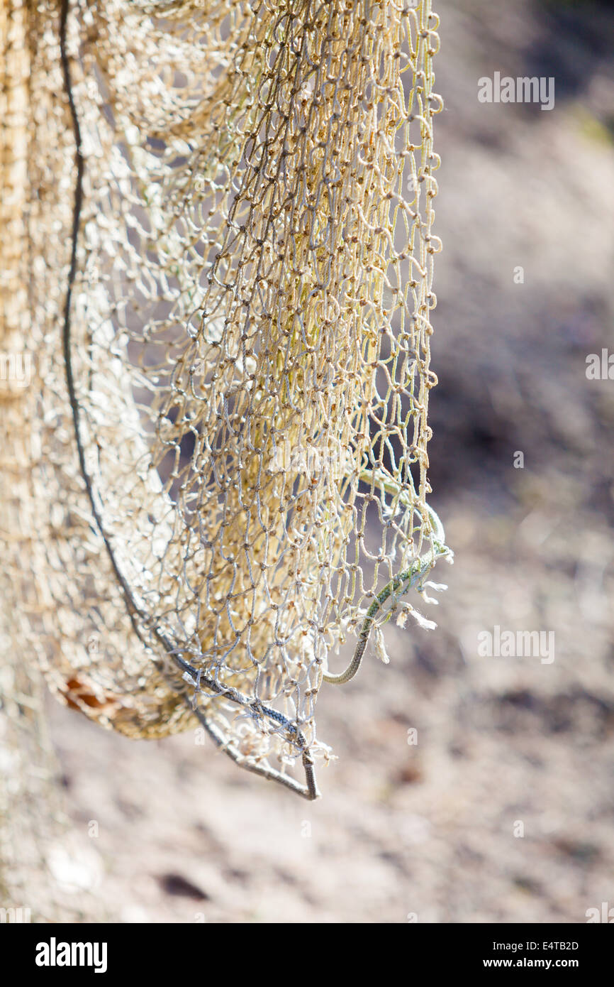 Fishing equipment. Closeup of old net. White fishnet on shore outdoor ...