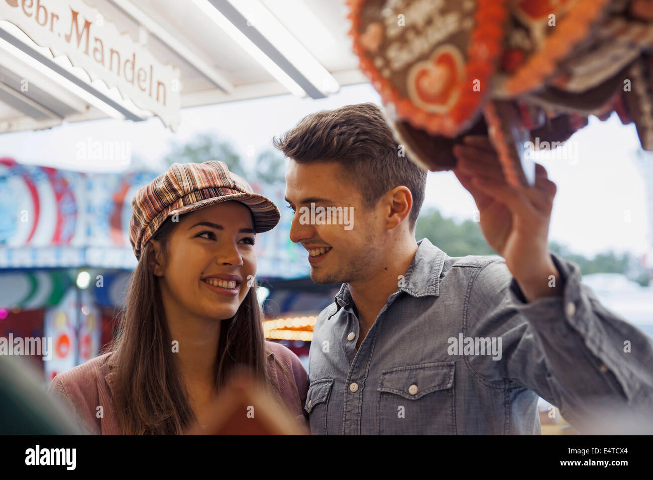 Close-up of young couple having fun at amusement park, Germany Stock ...