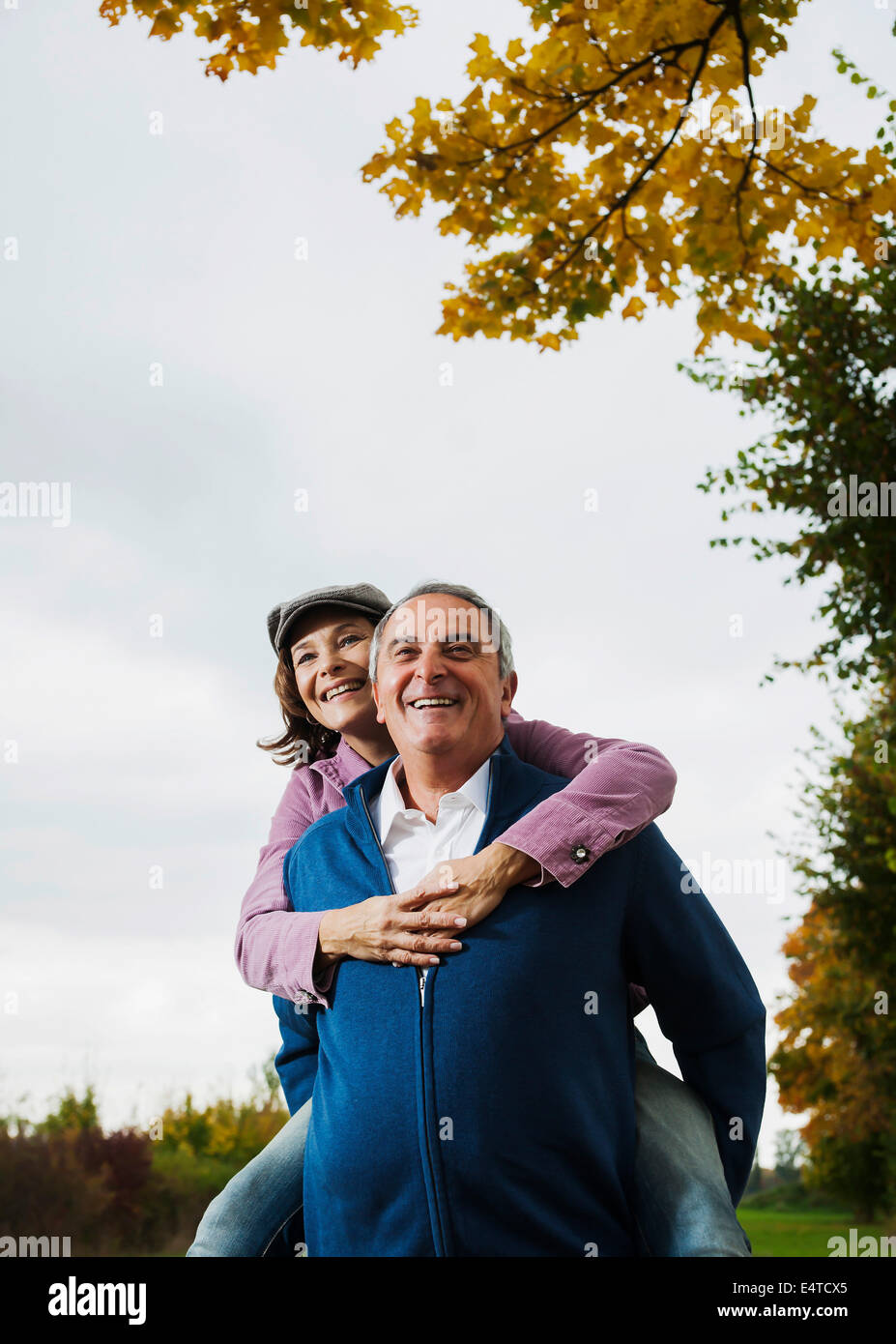 Man giving woman piggyback ride, Mannheim, Baden-Wurttemberg, Germany ...
