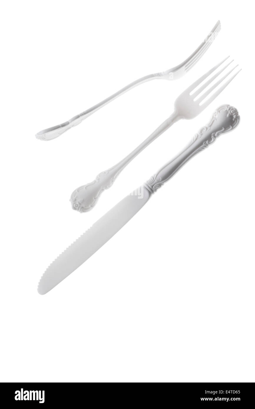 Two fancy white plastic forks and one fancy white plastic knife on a ...