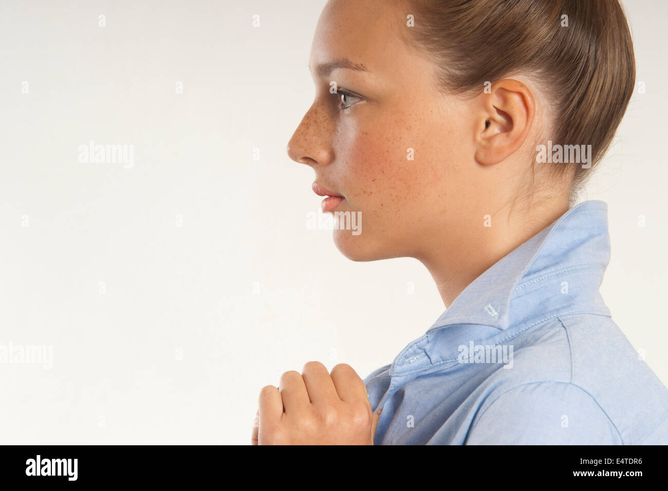 Close-up portrait of young woman, profile, studio shot on white ...