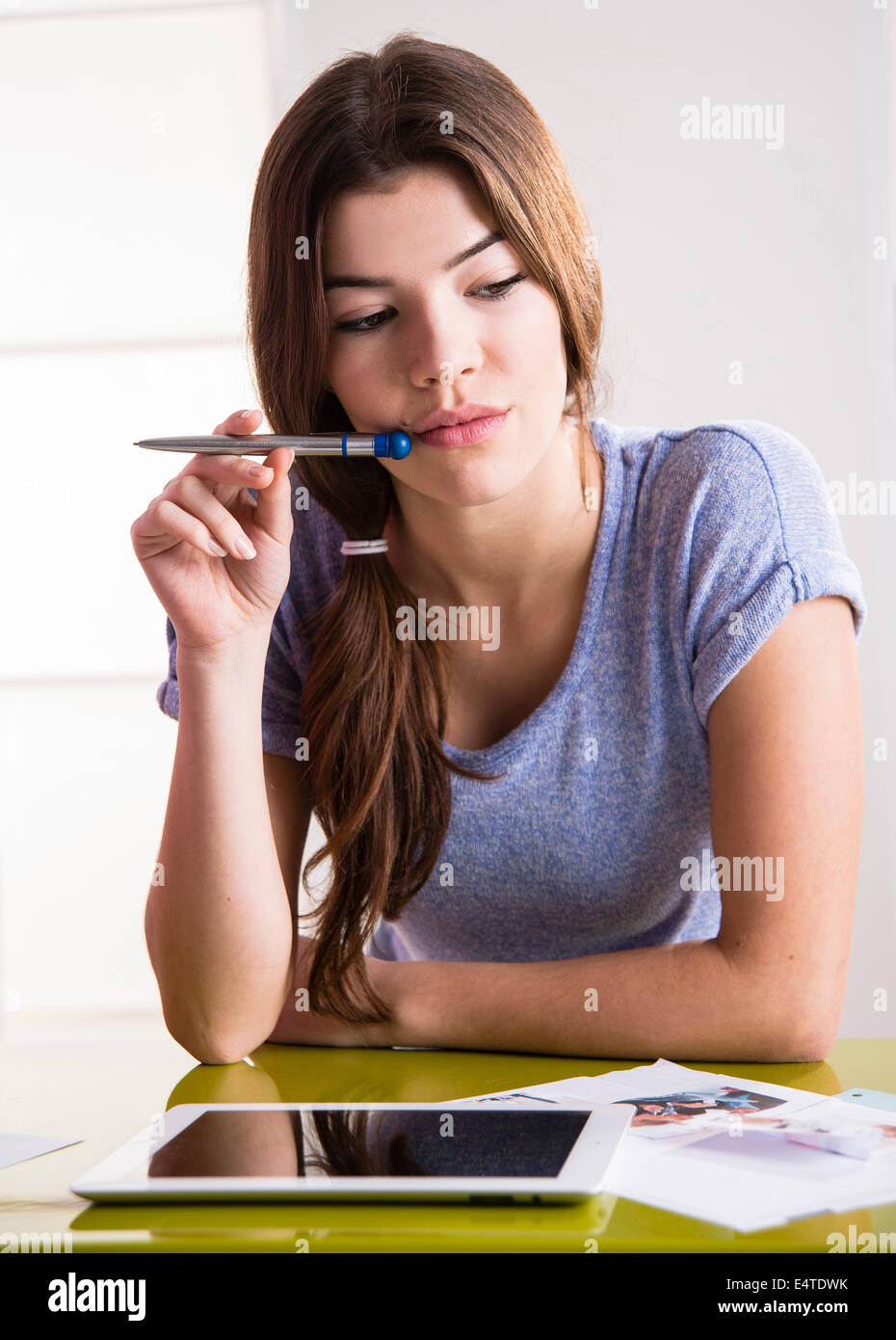 Young woman with pen and tablet computer, thinking and problem solving ... Young woman with pen and tablet computer, thinking and problem solving ...