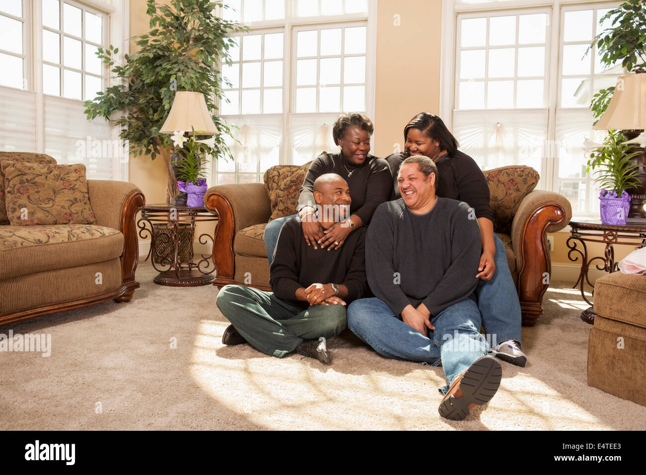 Portrait of Adult Family in Living Room Stock Photo - Alamy