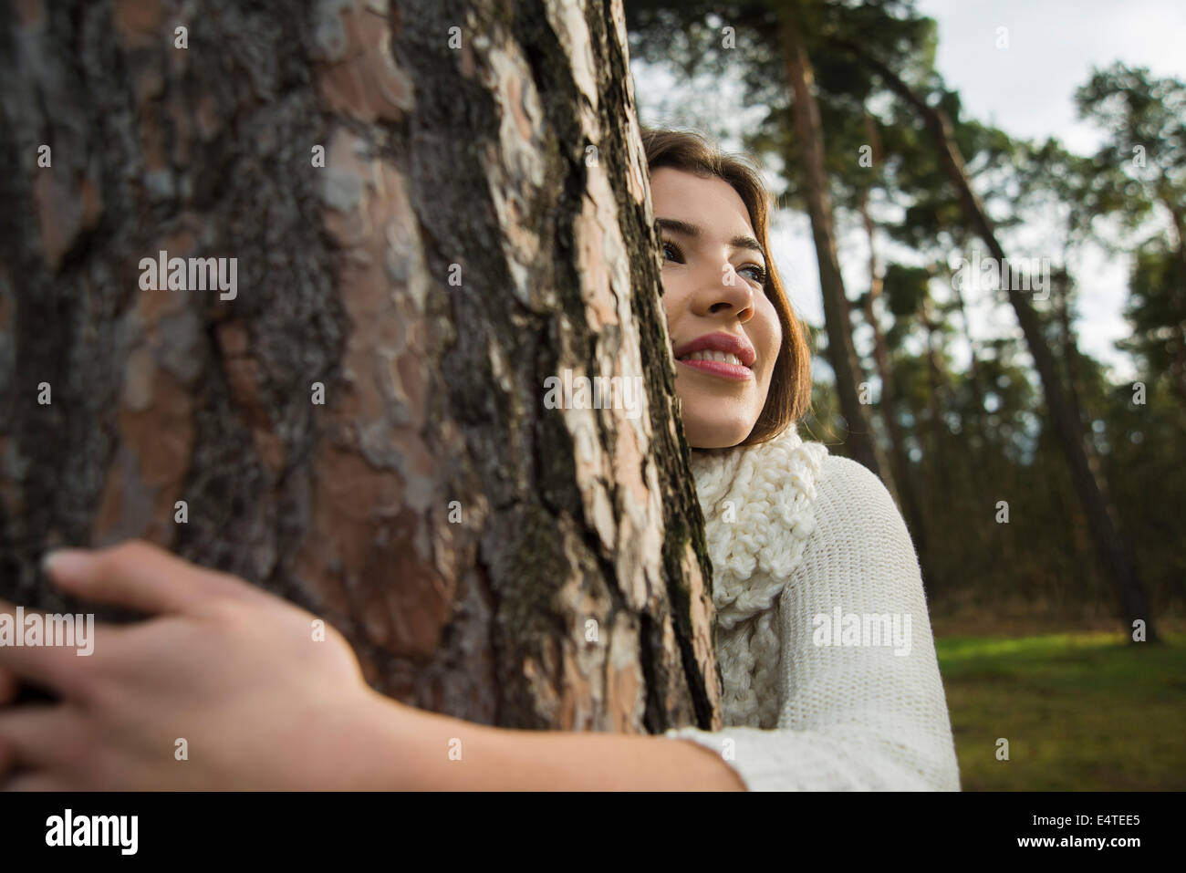 Young Woman Hugging Tree Trunk, Mannheim, Baden-Wurttemberg, Germany ...