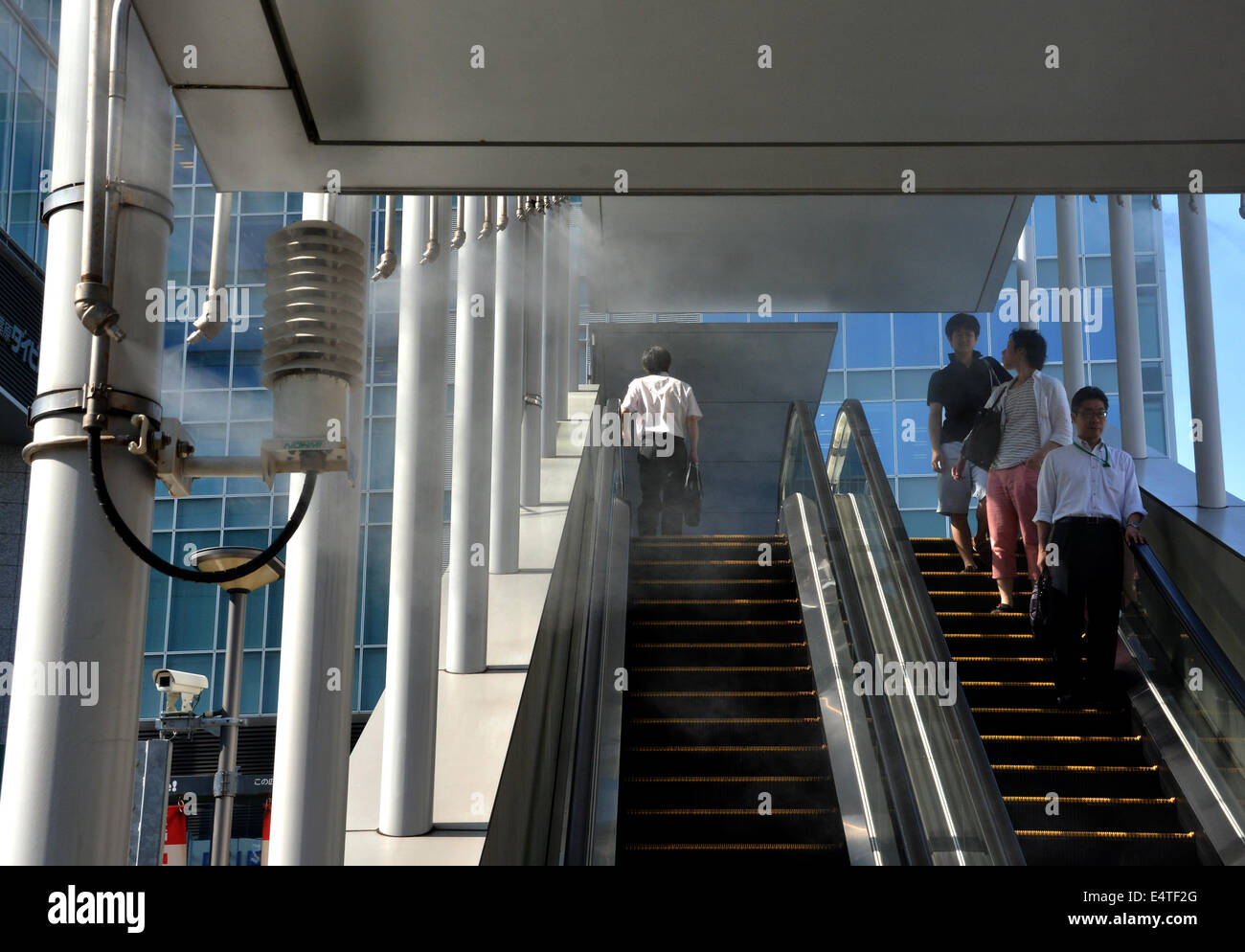 Tokyo, Japan. 16th July, 2014. A mist curtain gives a relief to ...