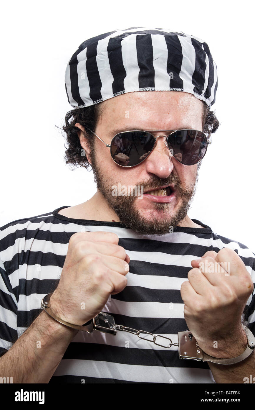 Locked, Desperate, portrait of a man prisoner in prison garb, over ...