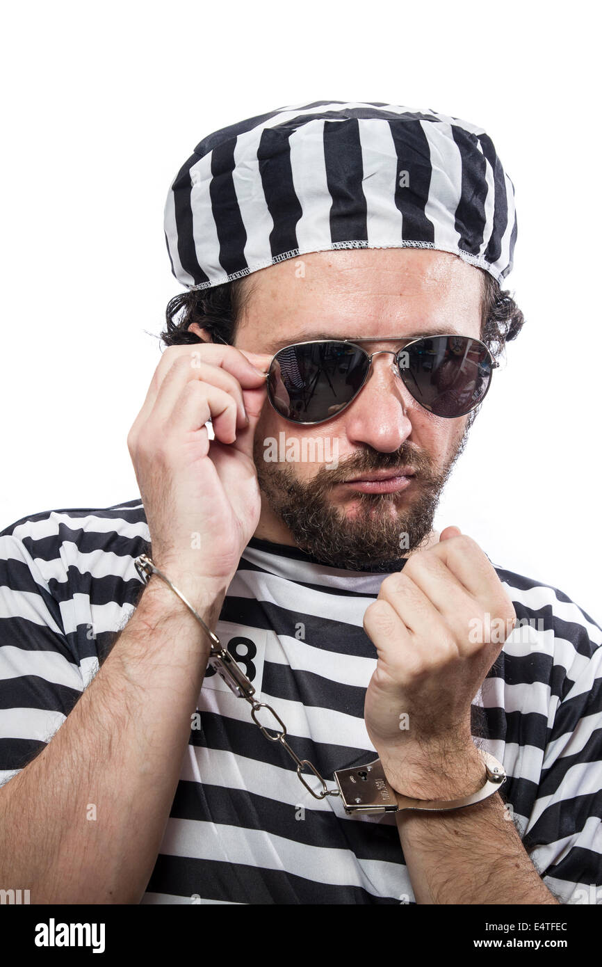 Desperate, portrait of a man prisoner in prison garb, over white ...