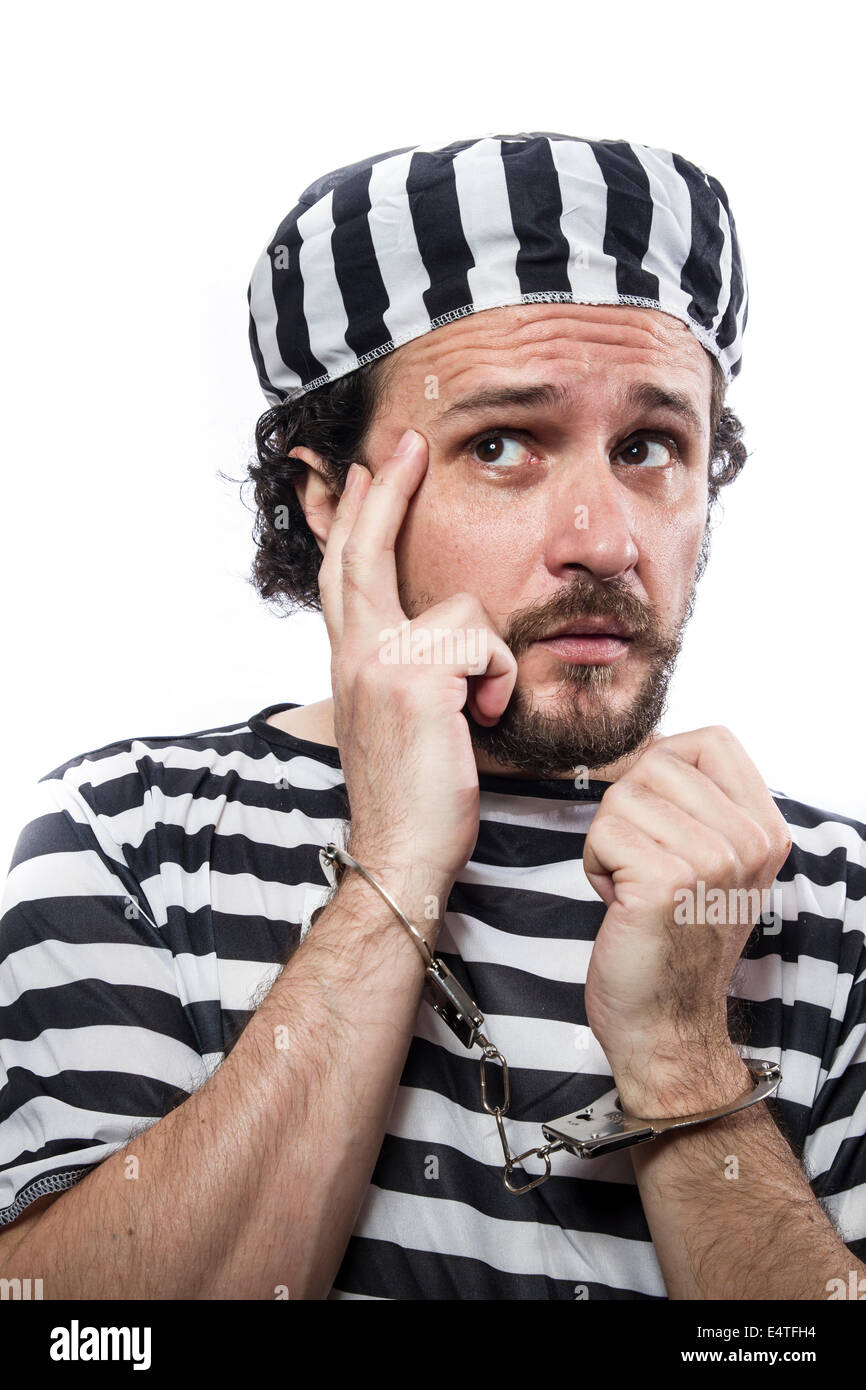 Desperate, portrait of a man prisoner in prison garb, over white ...