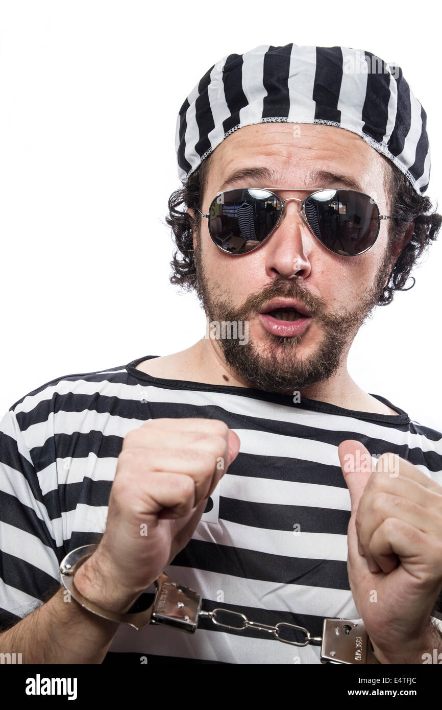 Desperate, portrait of a man prisoner in prison garb, over white ...