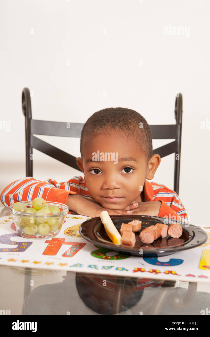 Boy Unhappy with his Lunch at Kitchen Table Stock Photo - Alamy