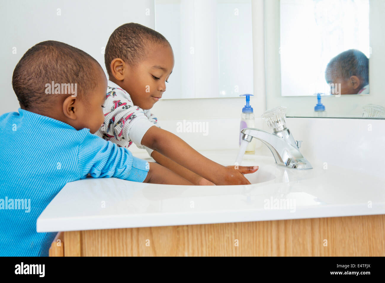 Boys Washing Hands in Bathroom Sink Stock Photo - Alamy