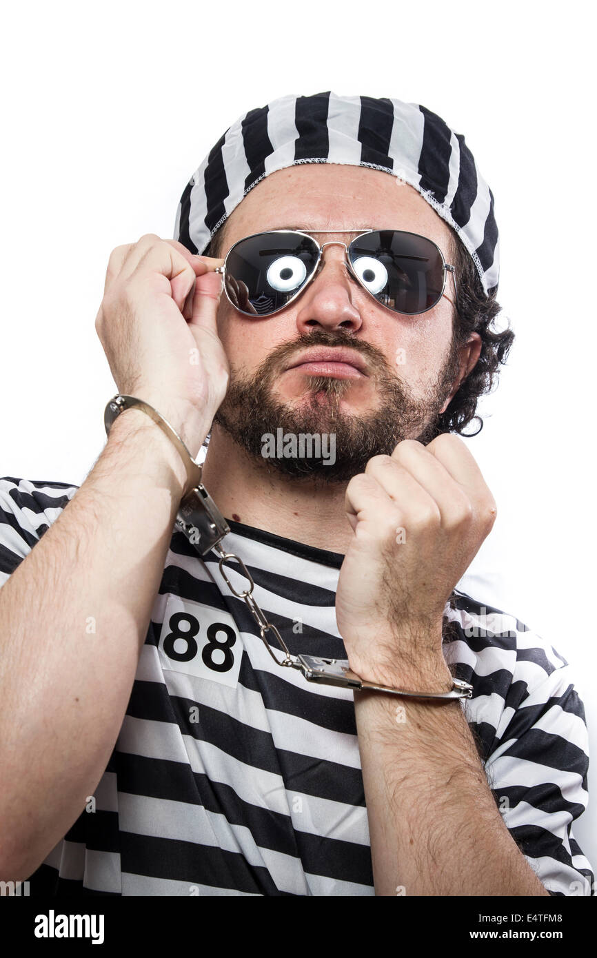 Desperate, portrait of a man prisoner in prison garb, over white ...