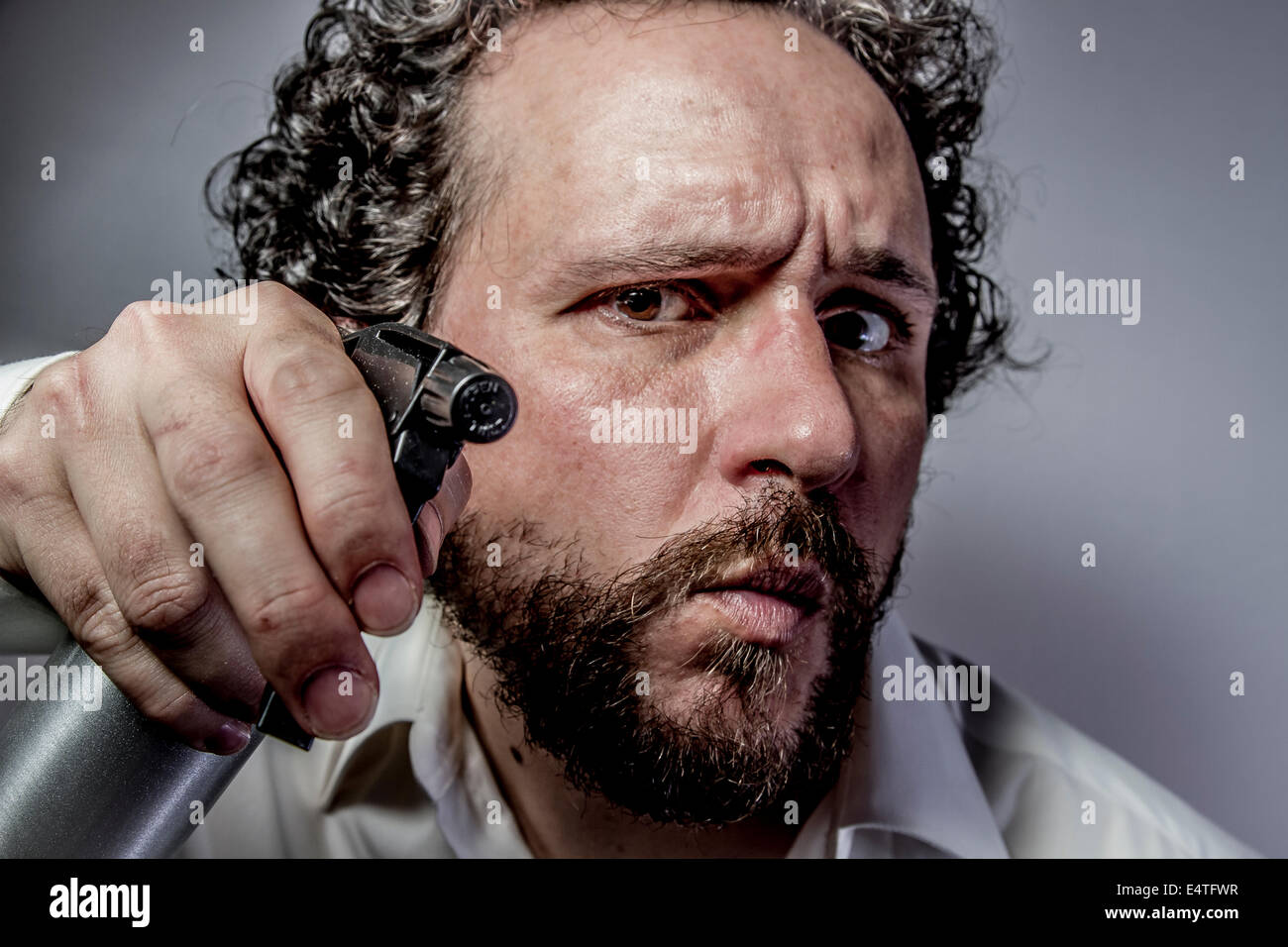 cleaning spray, man with intense expression, white shirt Stock Photo ...