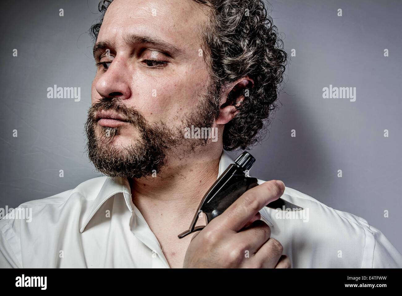 cleaning spray, man with intense expression, white shirt Stock Photo ...