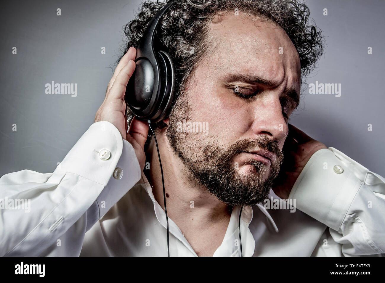 enjoy the music, man with intense expression, white shirt Stock Photo ...