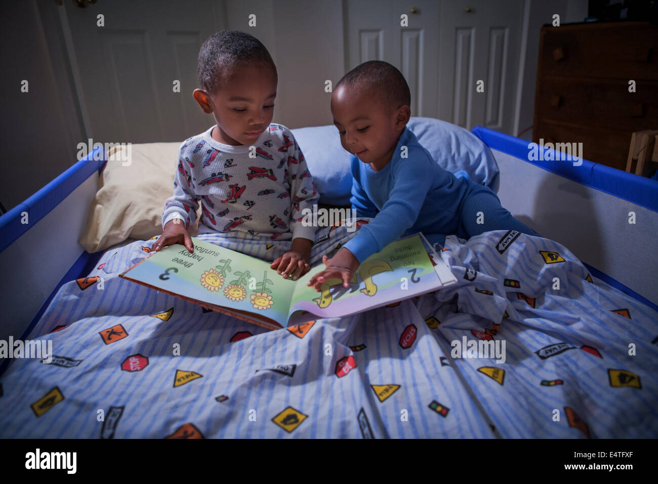 Brothers Reading together at Bedtime Stock Photo - Alamy