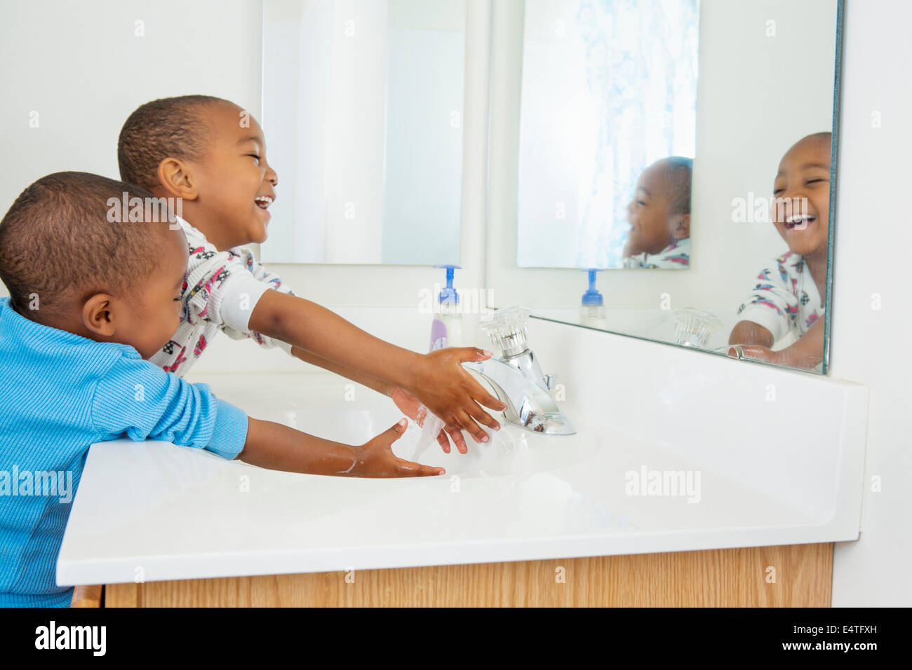 Boys Washing Hands in Bathroom Sink Stock Photo - Alamy
